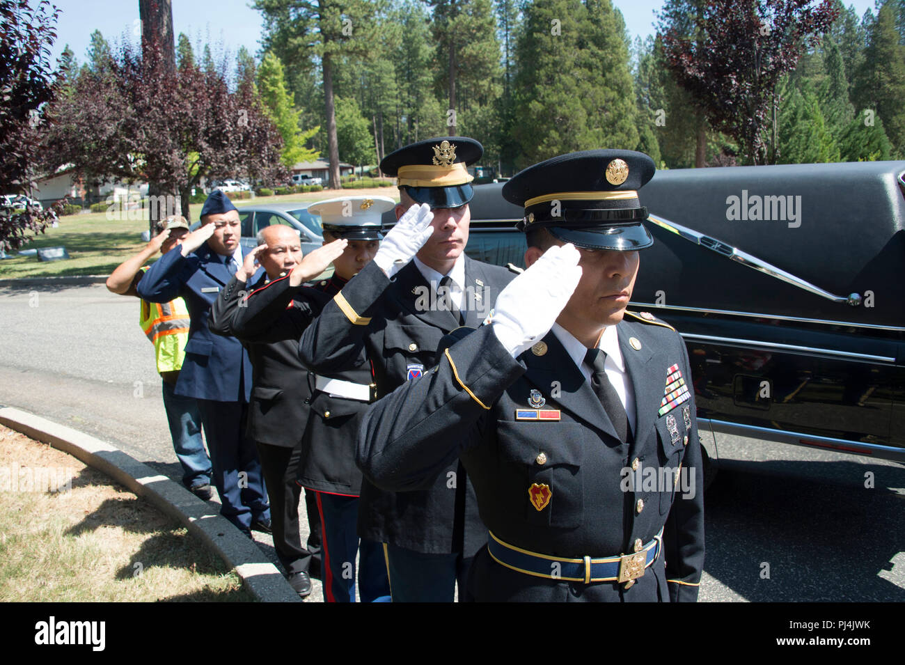 Capt Steven Lilly leads a column file of salutes for the casket of ...