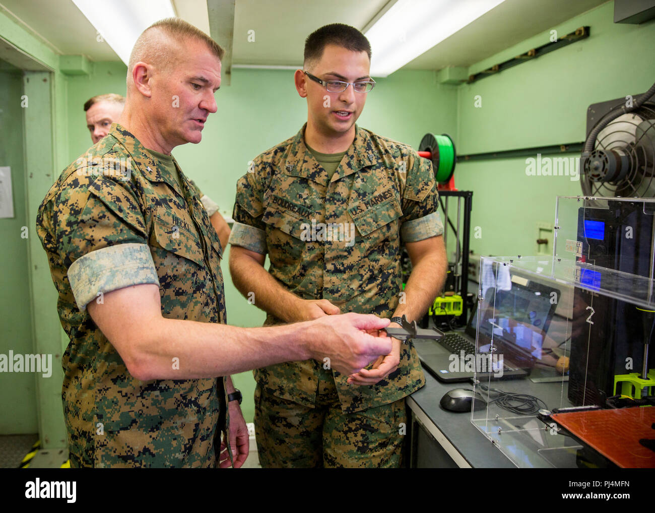 U.S. Marine Corps Brig. Gen. Karsten S. Heckl speaks to a Marine with ...