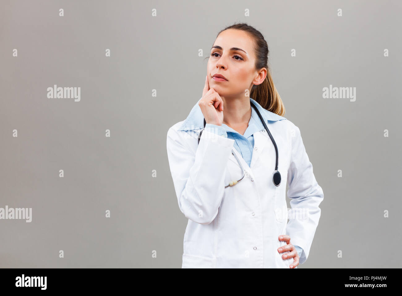 Worried female doctor thinking Stock Photo - Alamy