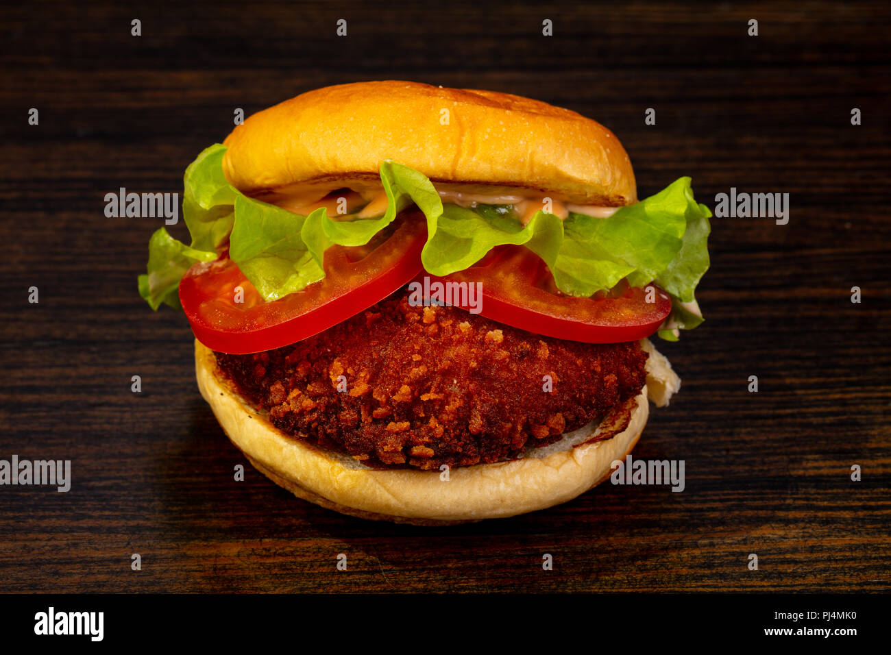 Tasty hot burger over wooden background Stock Photo - Alamy