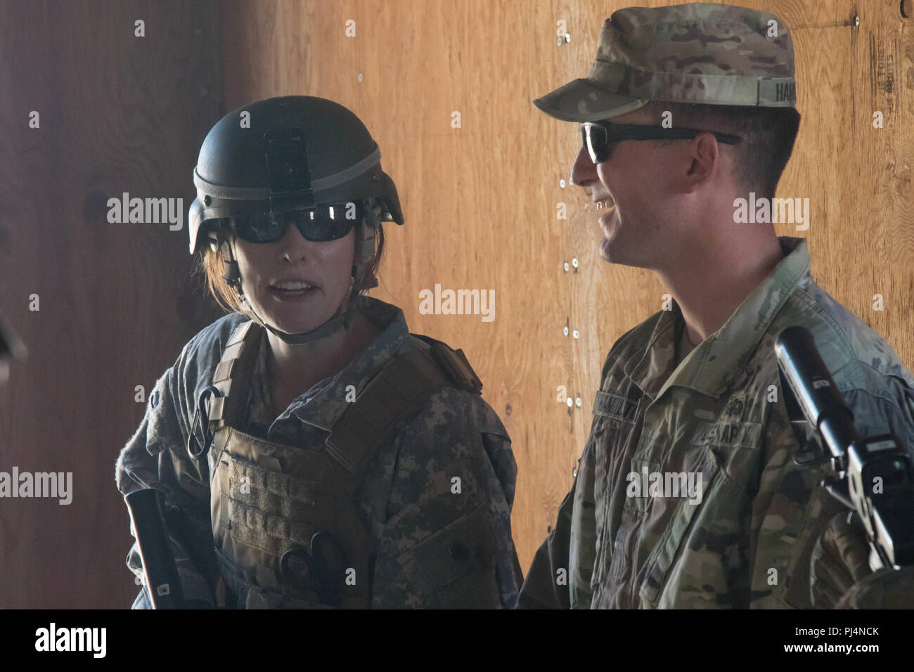 National Training Center, Calif.- Actress Milla Jovovich is briefed by ...