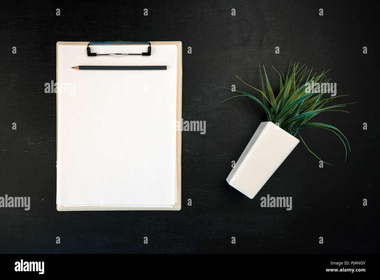 Notes clipboard with pencil and blank sheets of paper as mock up copy ...