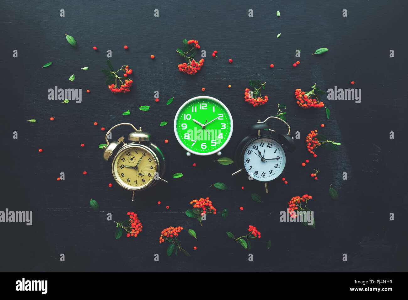 Ten past ten on three different alarm clock, flat lay top view minimal ...