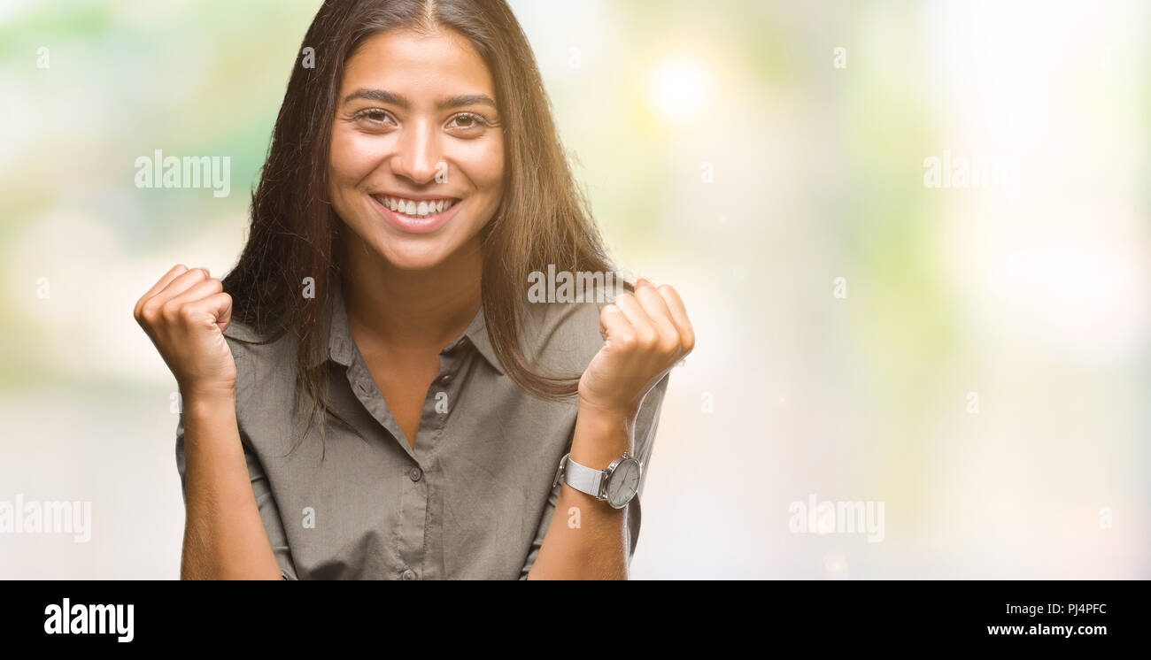 Young beautiful arab woman over isolated background celebrating ...