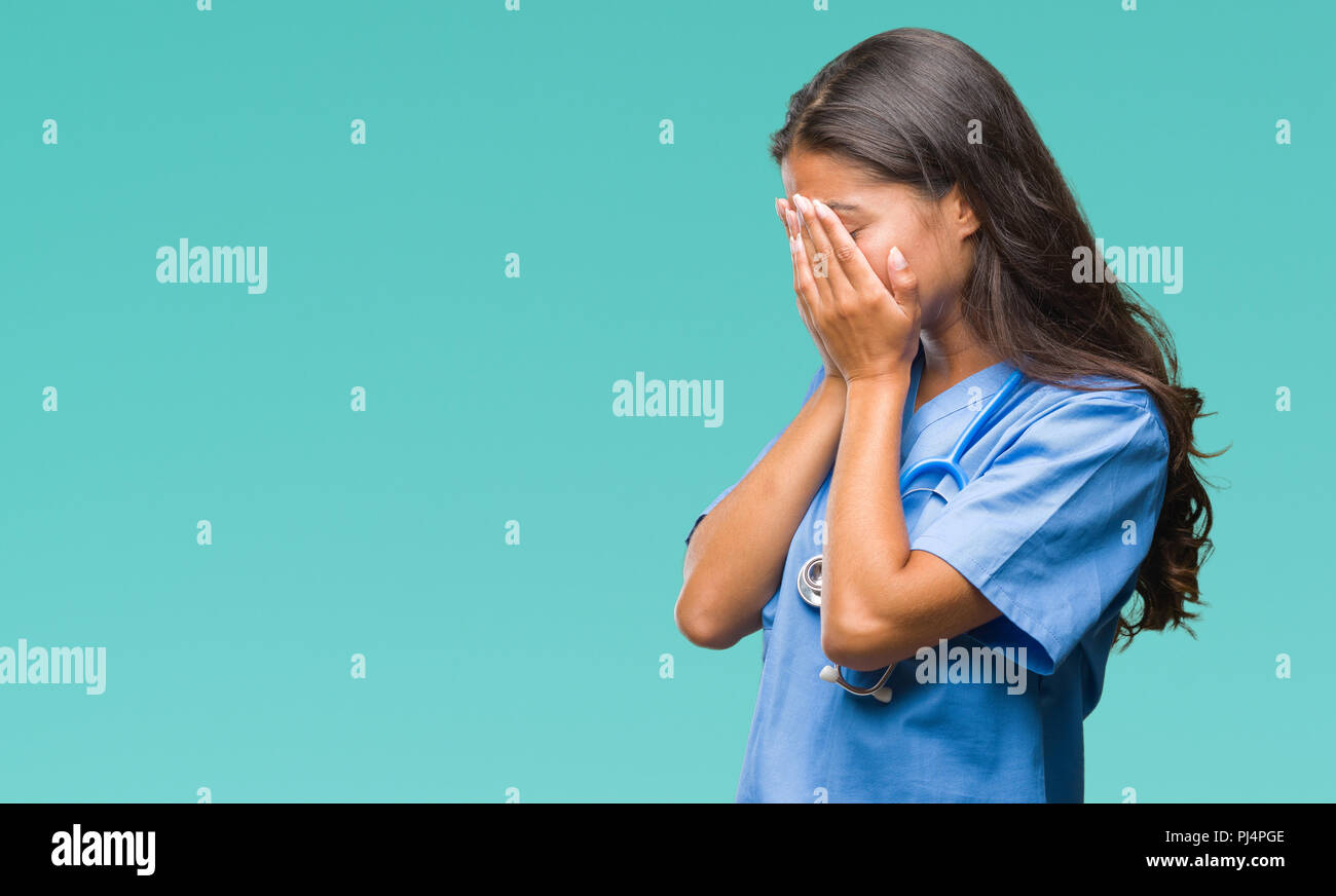 Young arab doctor surgeon woman over isolated background with sad ...