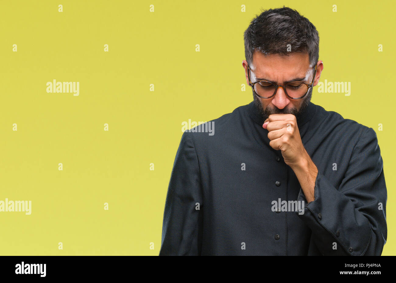 Adult hispanic catholic priest man over isolated background feeling ...