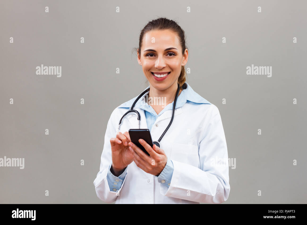 Beautiful female doctor texting hi-res stock photography and images - Alamy