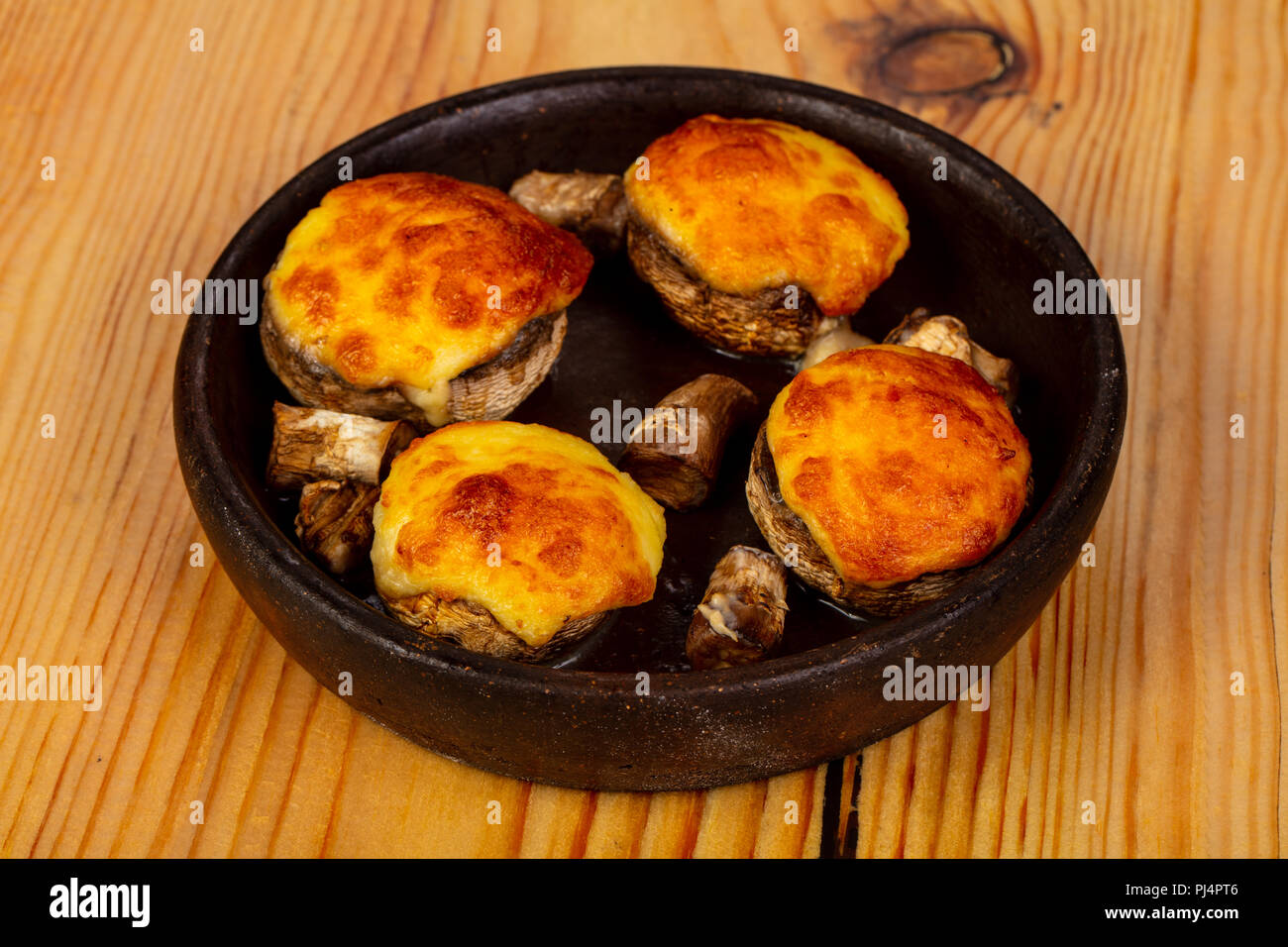 Baked champignon with cheese in the pan Stock Photo - Alamy