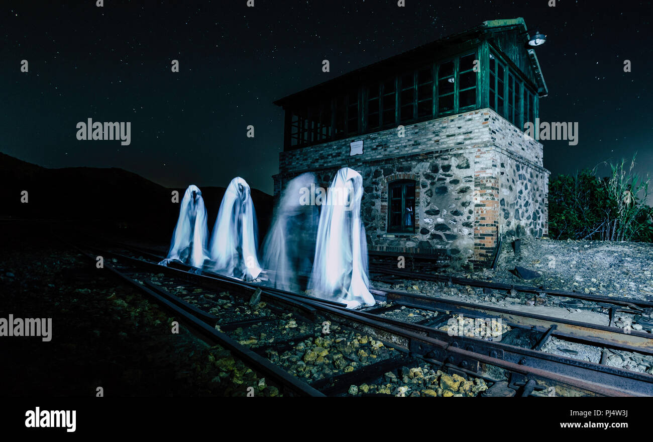 Four ghosts walking on the train track in front of the house Stock Photo - Alamy