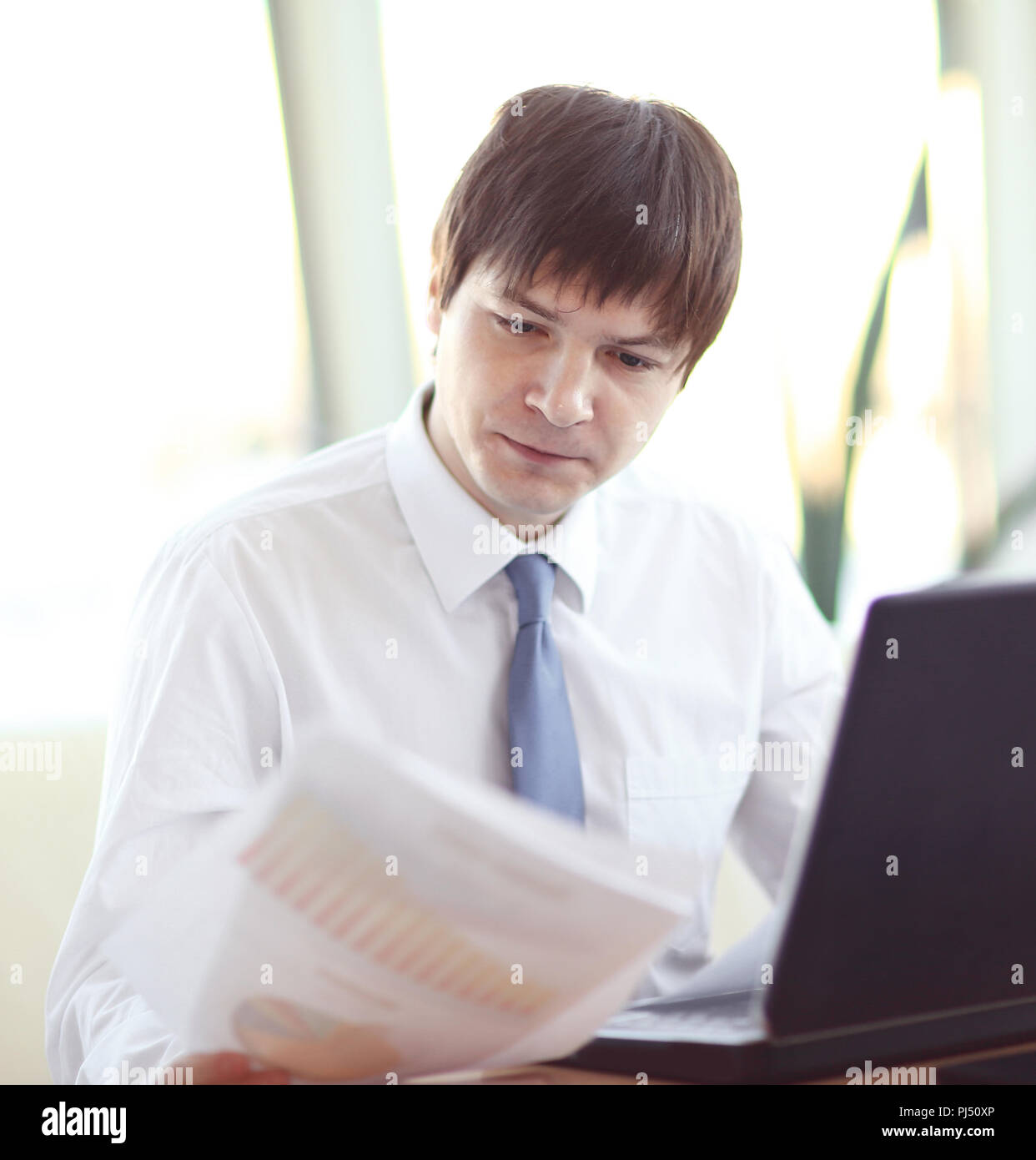 employee of the company working on the laptop Stock Photo - Alamy