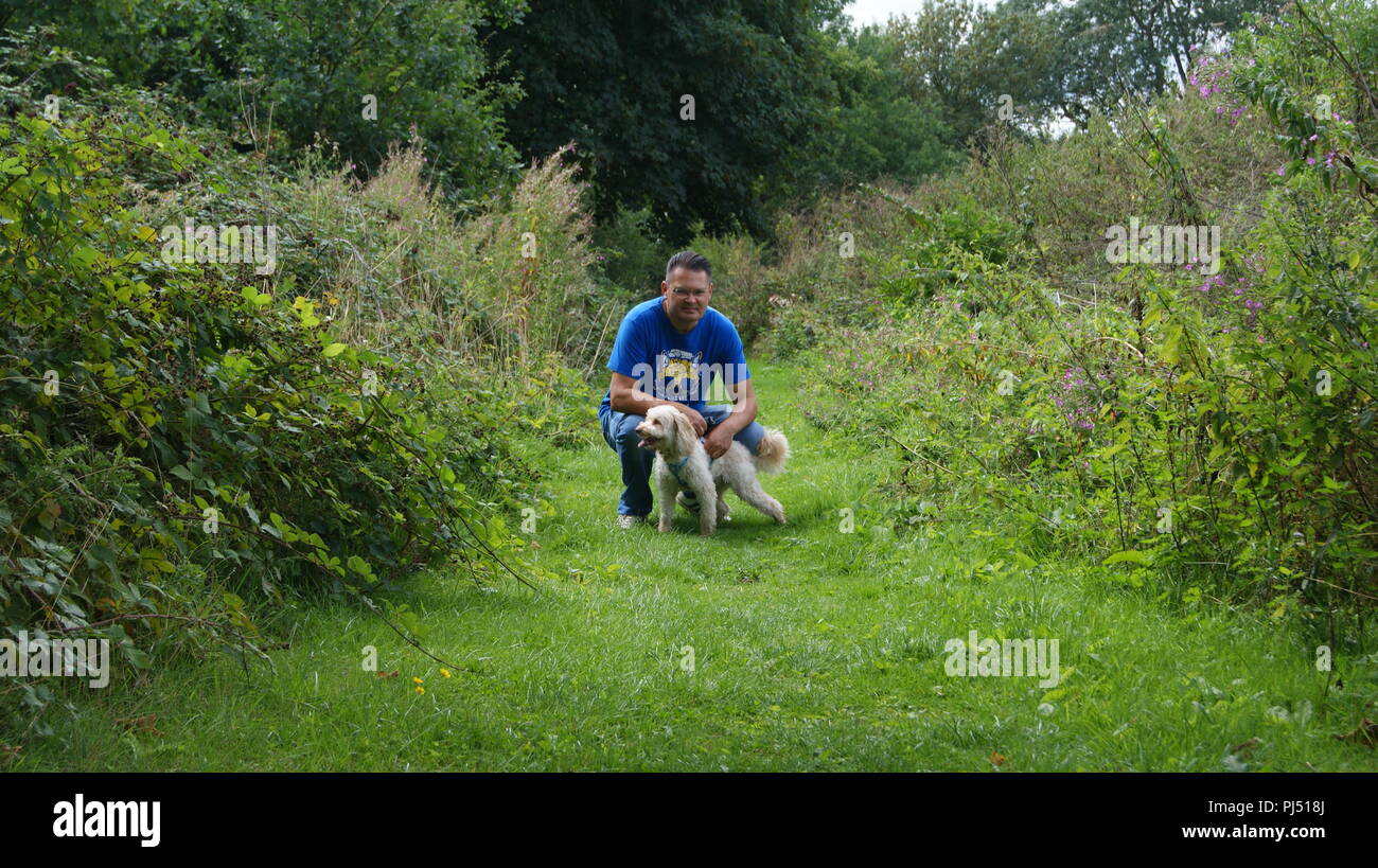 Dog walking at Newbold Comyn Nature Reserve UK Stock Photo - Alamy