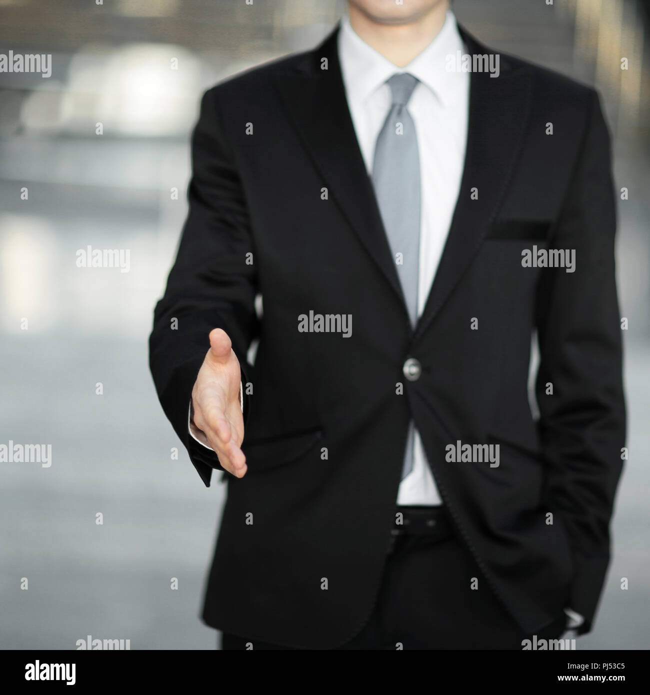 Businessman holding hand out handshake hi-res stock photography and ...