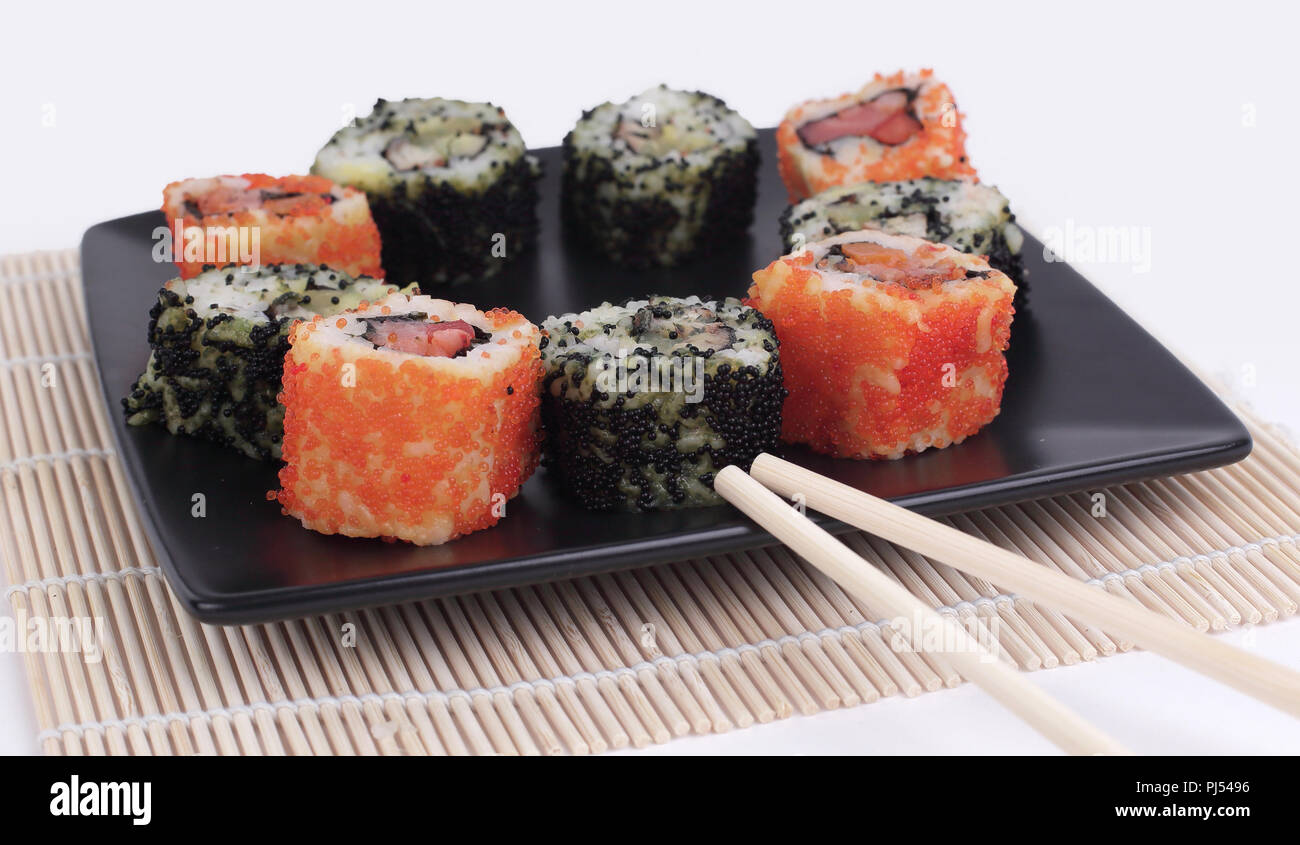 Sushi Set - different types of Maki sushi and chopsticks on a b Stock ...