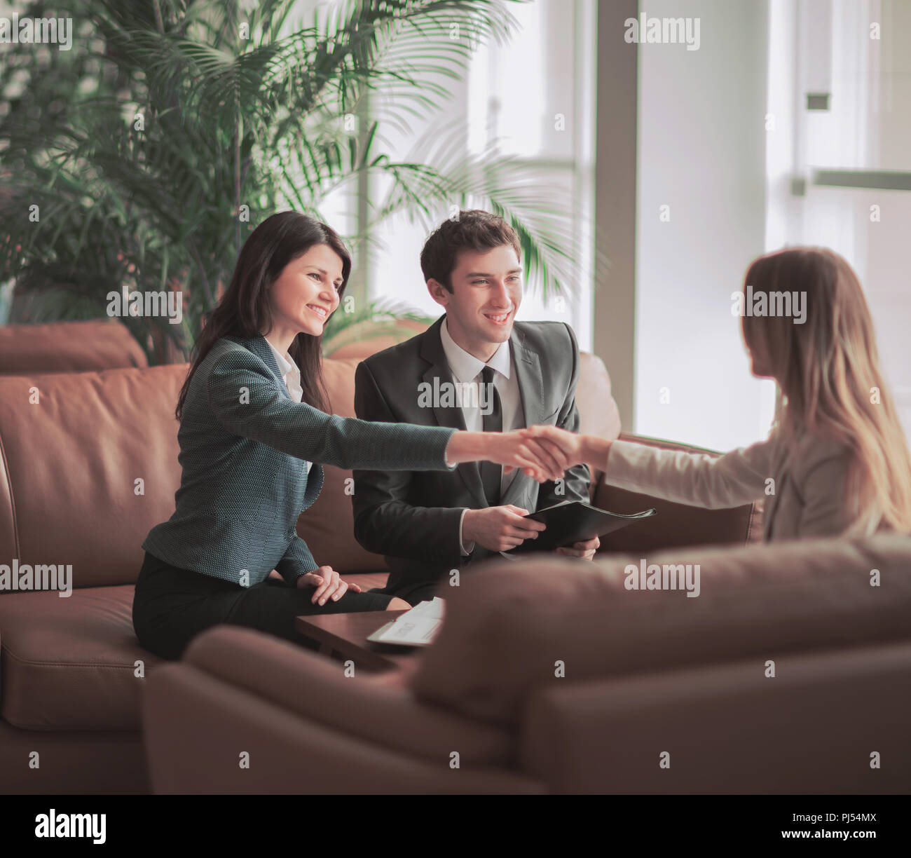 handshake of business partners after discussing a new contract in a ...