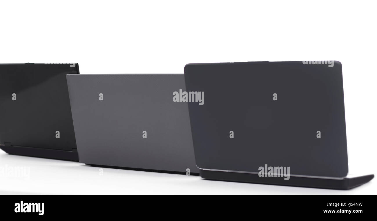 three open laptop in the workplace .isolated on white Stock Photo - Alamy