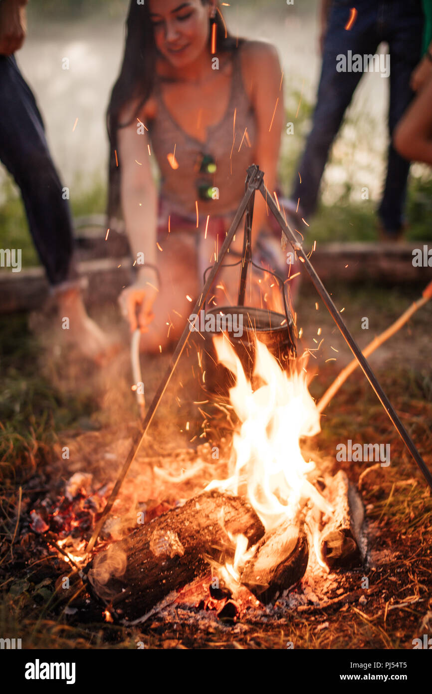 awesome girl is building a fire Stock Photo - Alamy