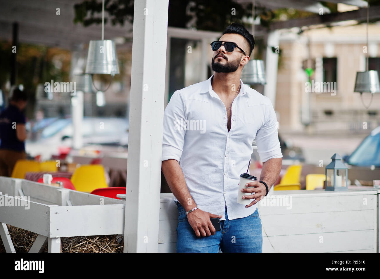 Stylish tall arabian man model in white shirt, jeans and sunglasses ...