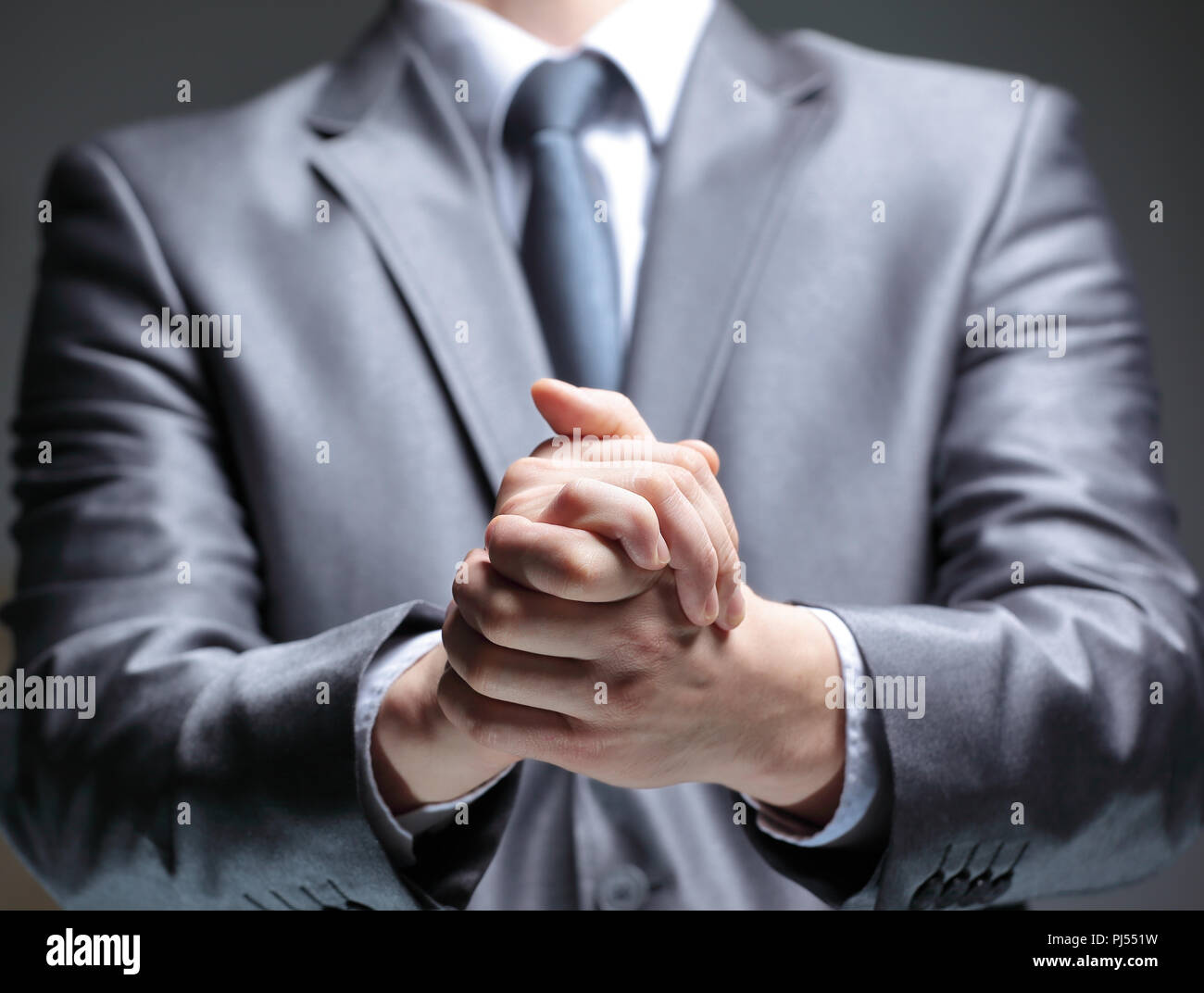 close up.businessman shows a sign with his hands.isolated on black ...