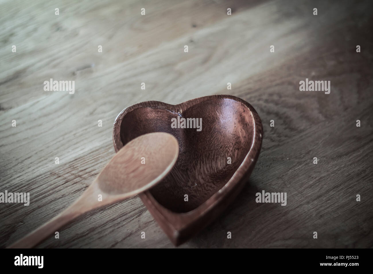 closeup. empty wooden salad bowl and wooden paddle Stock Photo - Alamy