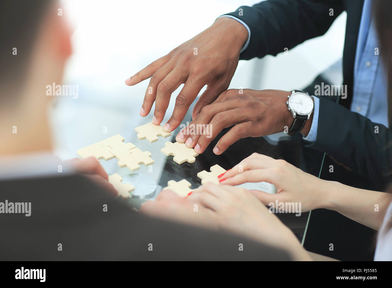 close up. business team assembling puzzle pieces Stock Photo - Alamy