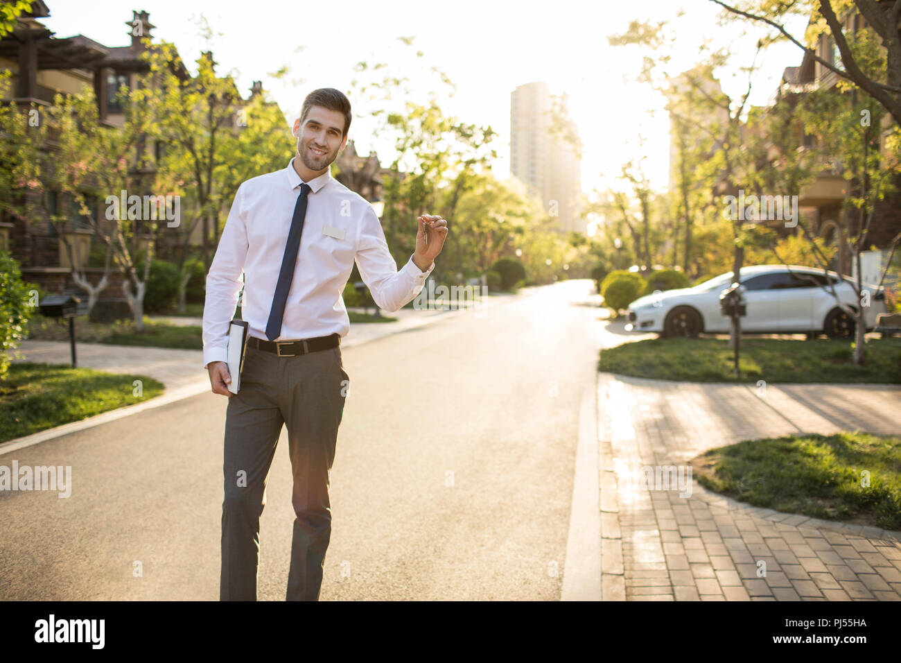 Confident businessman holding keys Stock Photo - Alamy