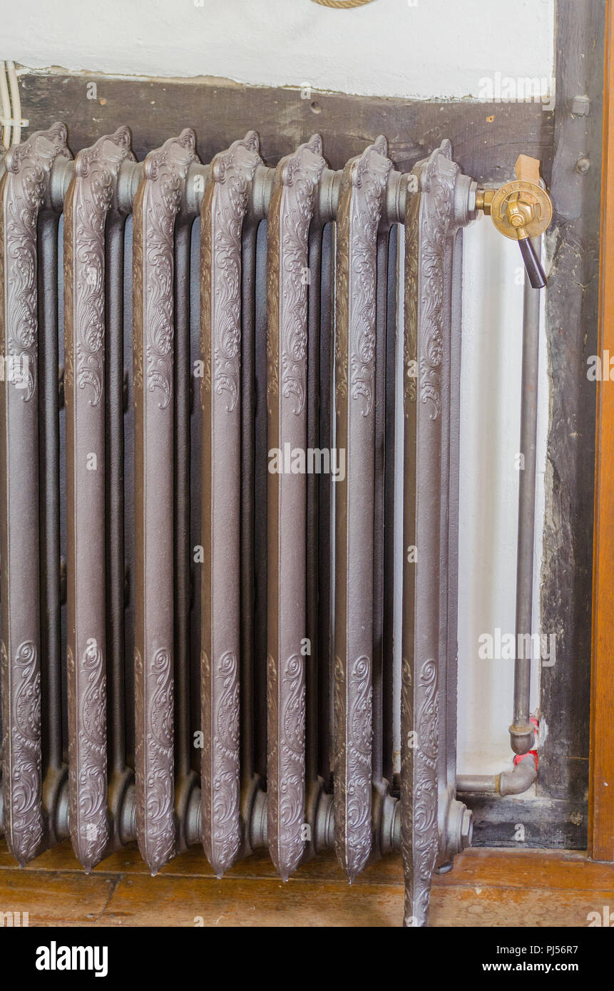 An antique vintage radiator of a central heating system Stock Photo - Alamy