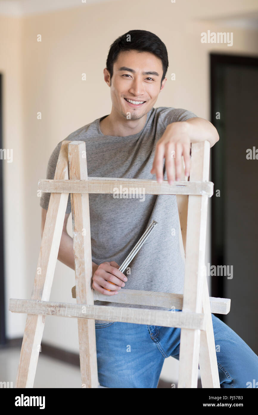Young man working on home renovation Stock Photo - Alamy