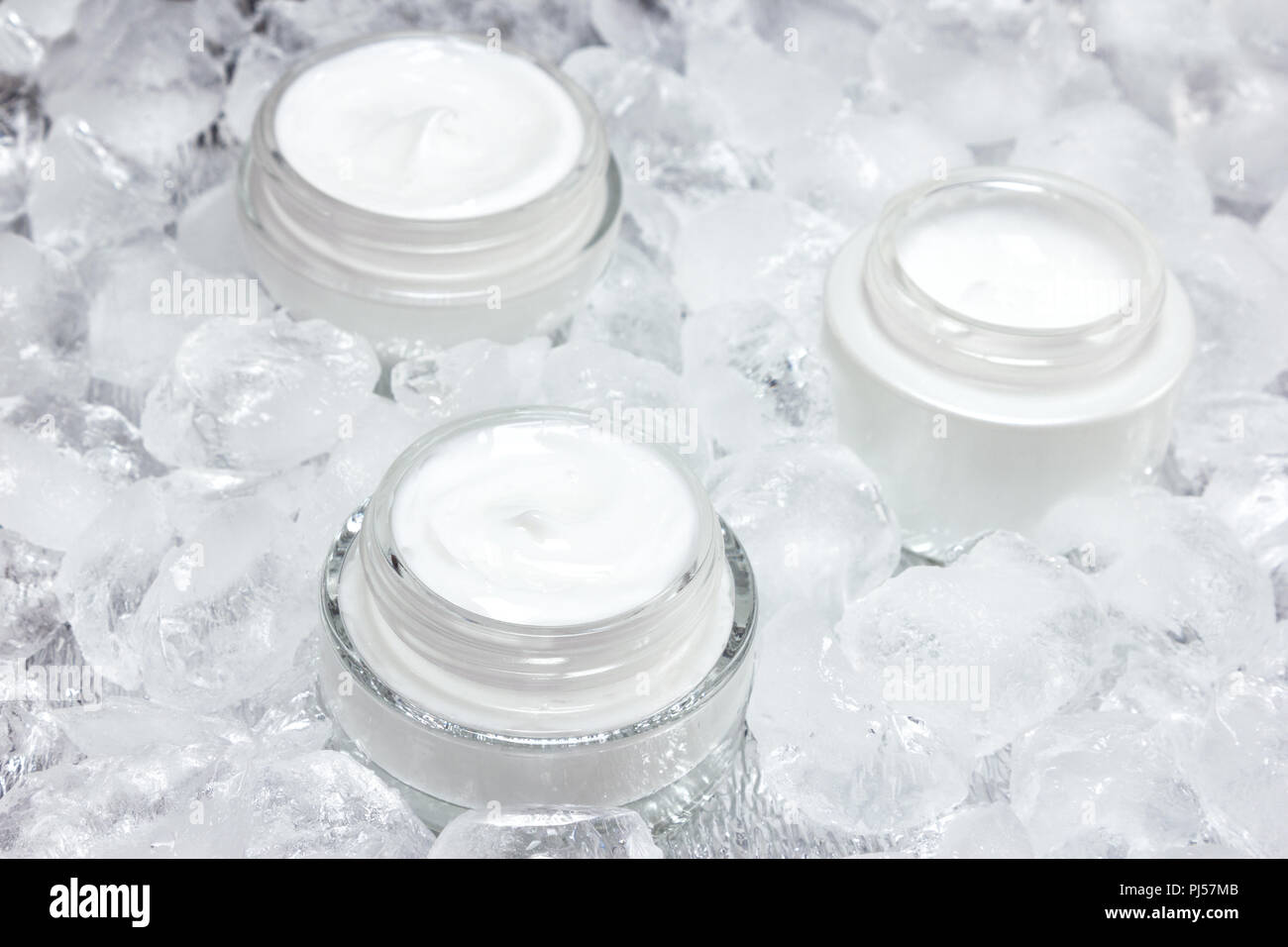 Cooling effect skin care products concept. Glass jars of cream ...