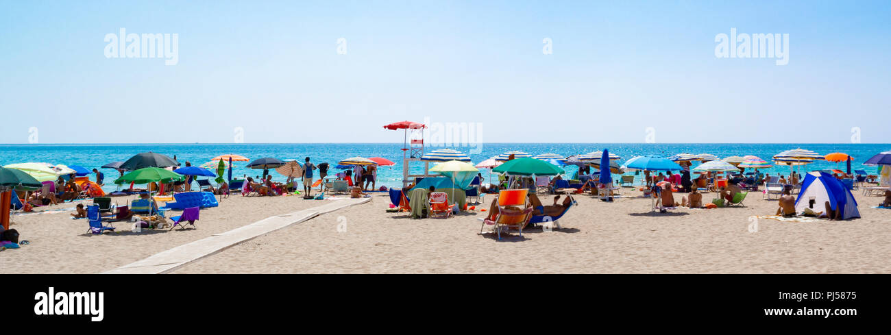Panoramic view of a public beach of lido marini with italian people ...