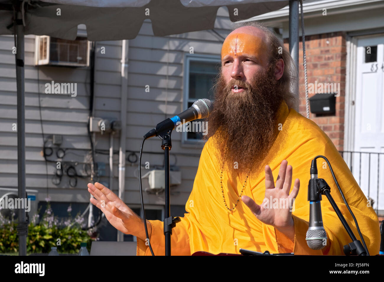 Swami Nikhilanand lecturing outdoors at the Janamashthmi holiday block ...