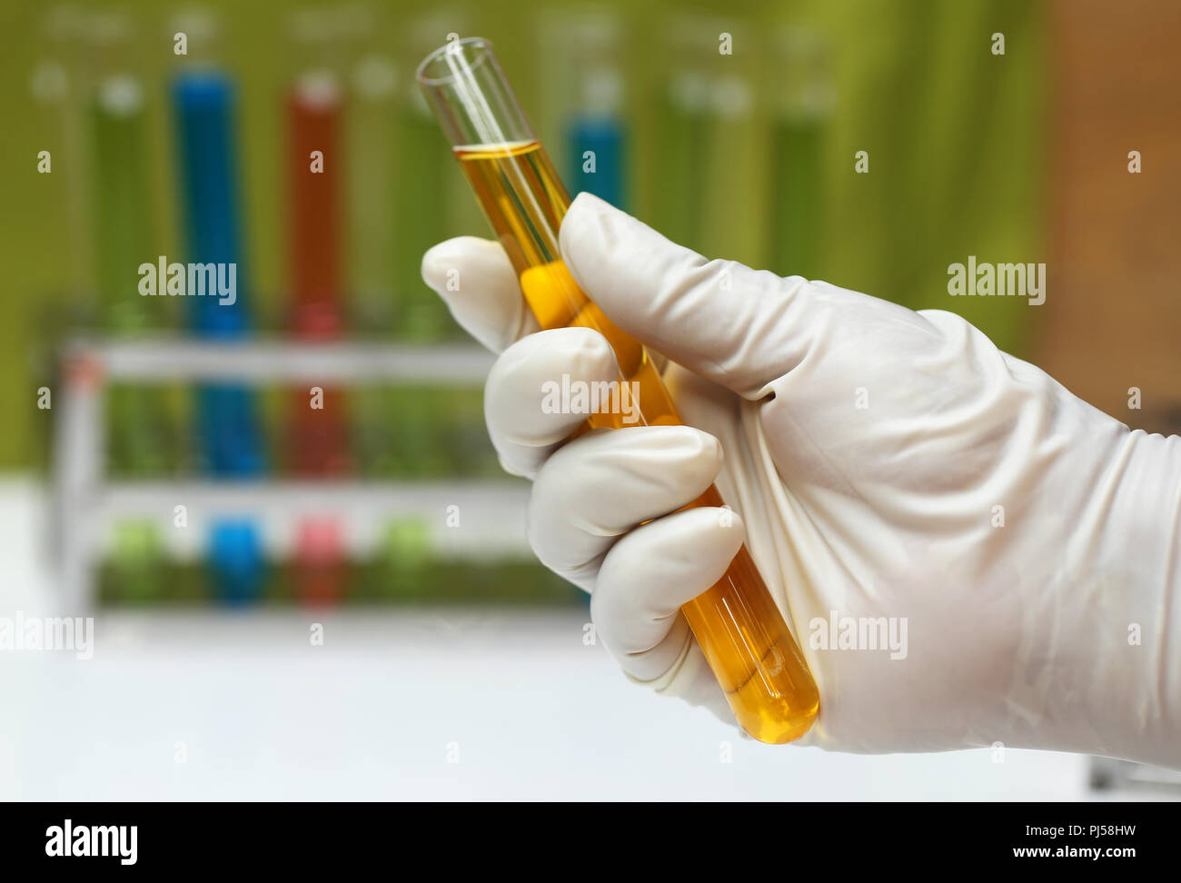 Hand holding a test tube with chemical sample in laboratory Stock Photo ...
