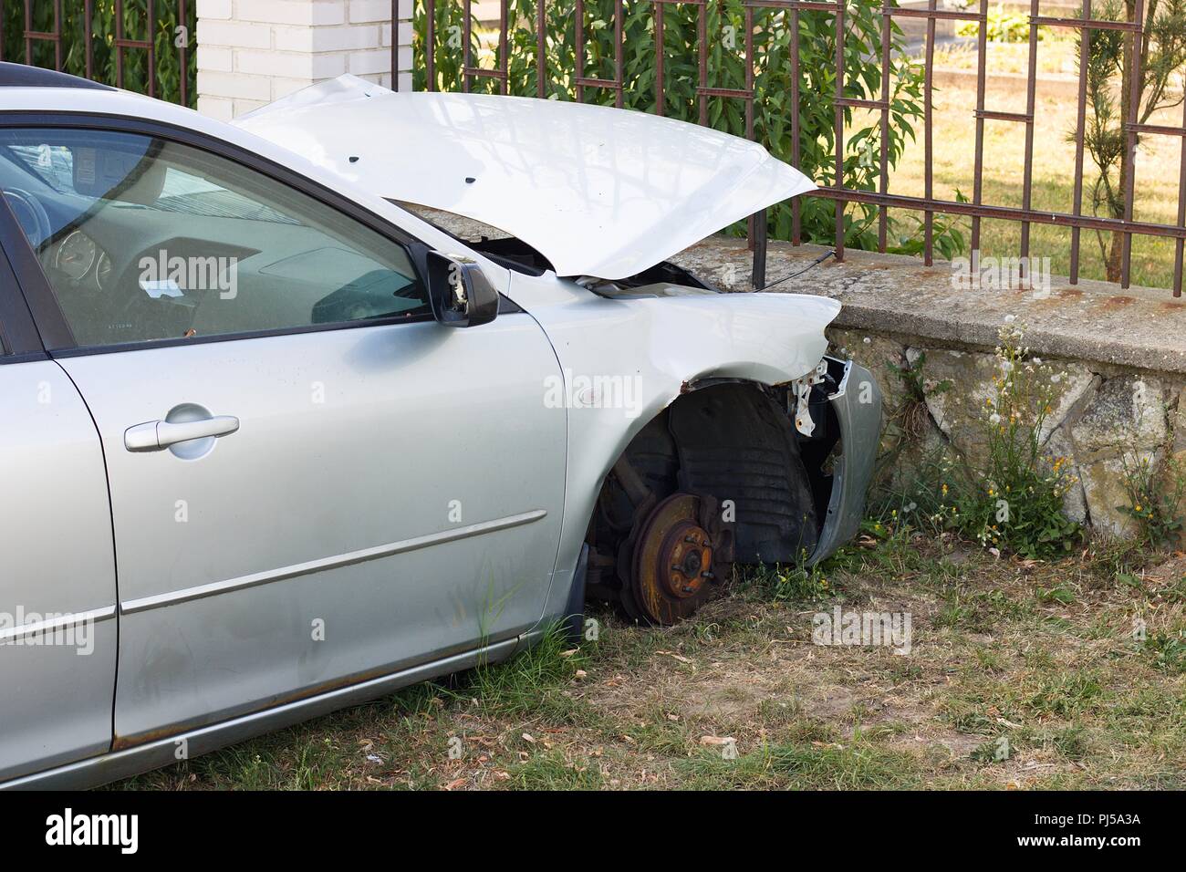Car crashed head on into the wall (of local cemetery). Picture taken ...