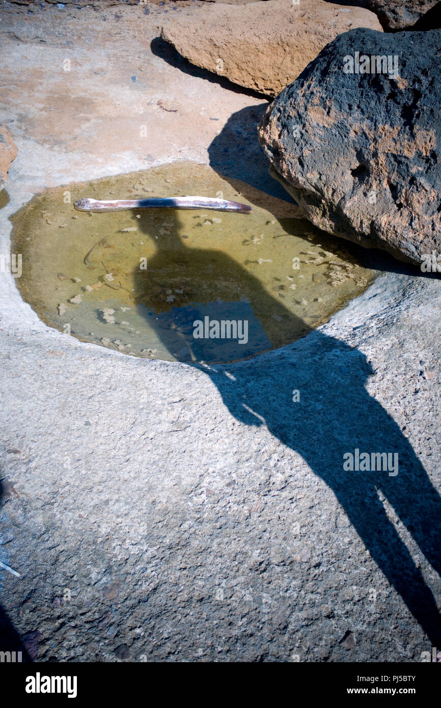 eerie photograph of shadow of standing man’s shadow falling across a ...