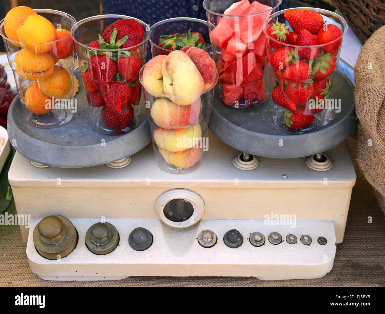 ancient scales with filled glasses of fresh fruits Stock Photo - Alamy