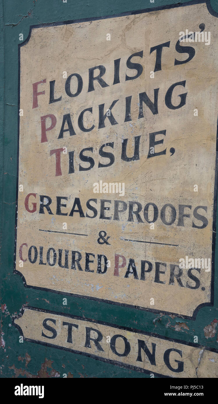 Old 1930s commercial signs on a wall by Spitalfields Church in the City ...