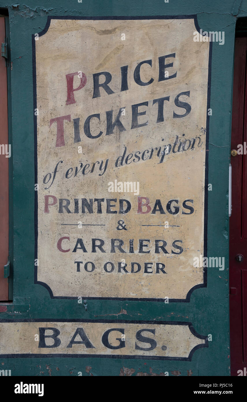 Old 1930s commercial signs on a wall by Spitalfields Church in the City ...
