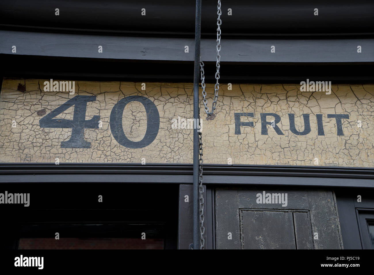 Old 1930s commercial signs on a wall by Spitalfields Church in the City ...