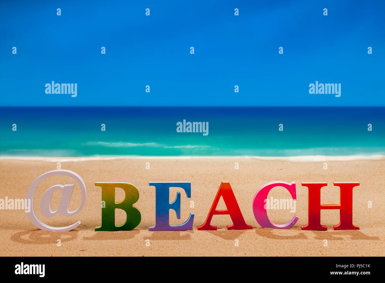 @beach written in colorful wood letters with sea shell at the beach ...