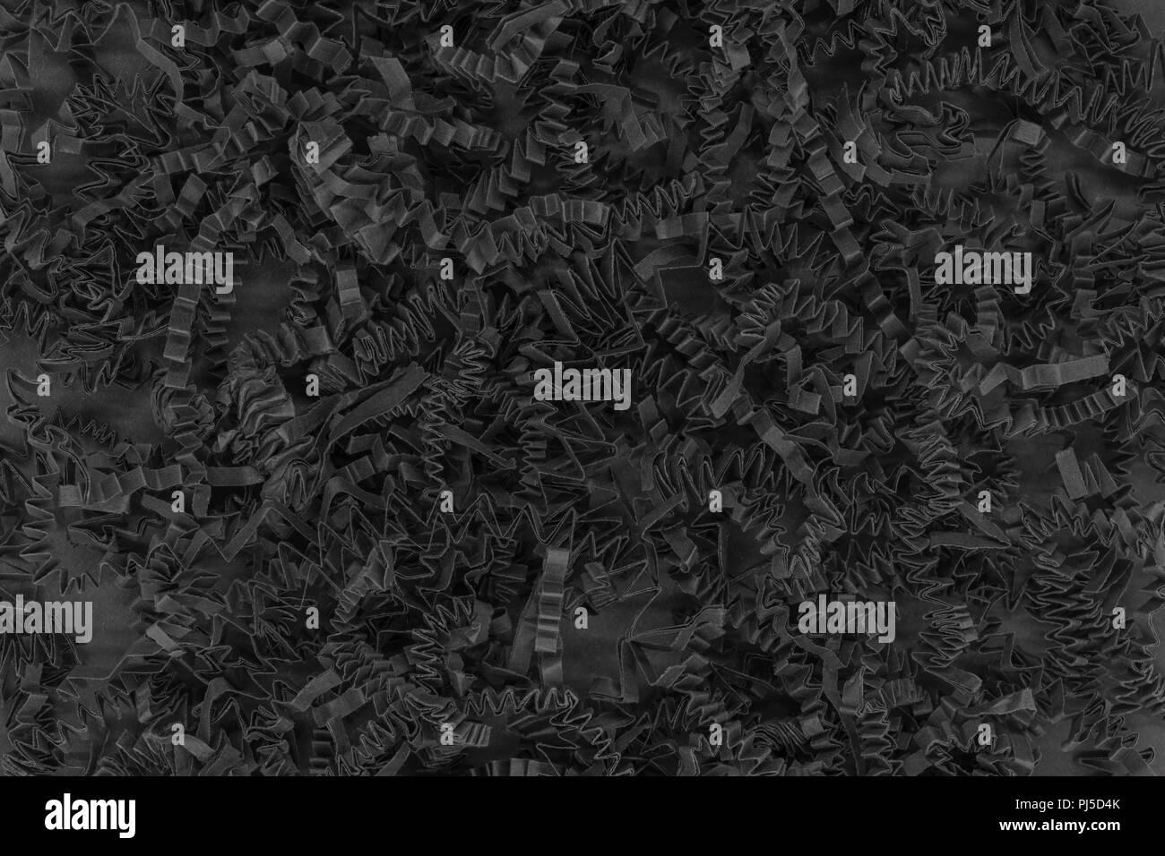 Bunch of shredder black curly carton paper strips background placed on ...