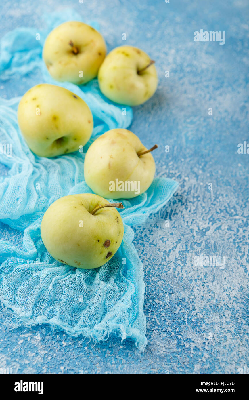 Fresh green apples on light blue background Stock Photo - Alamy