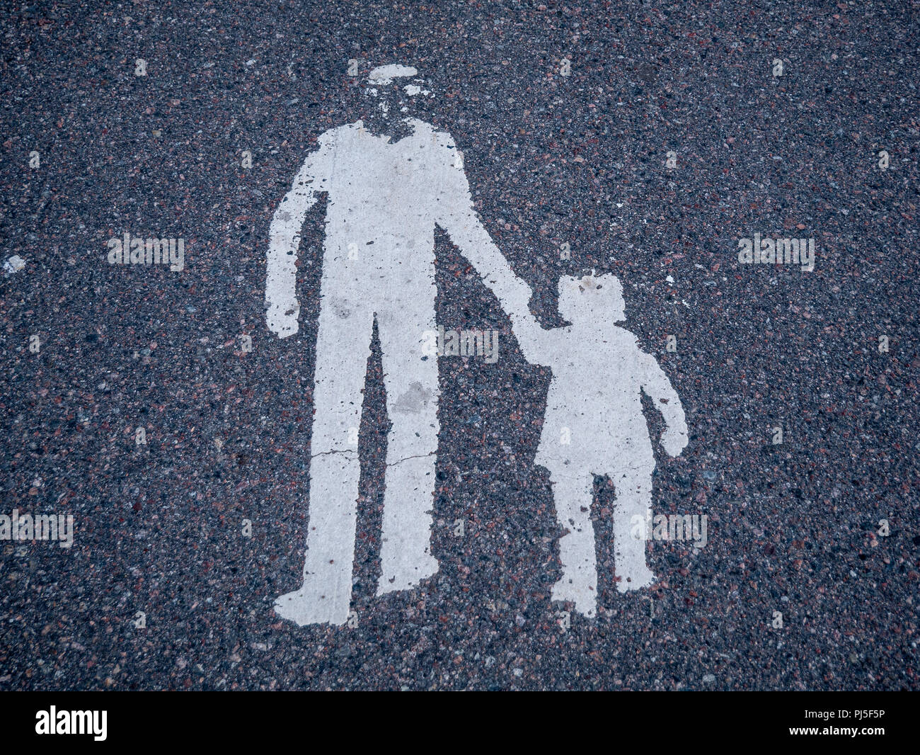 White sign of man and children on grey asphlat Stock Photo - Alamy