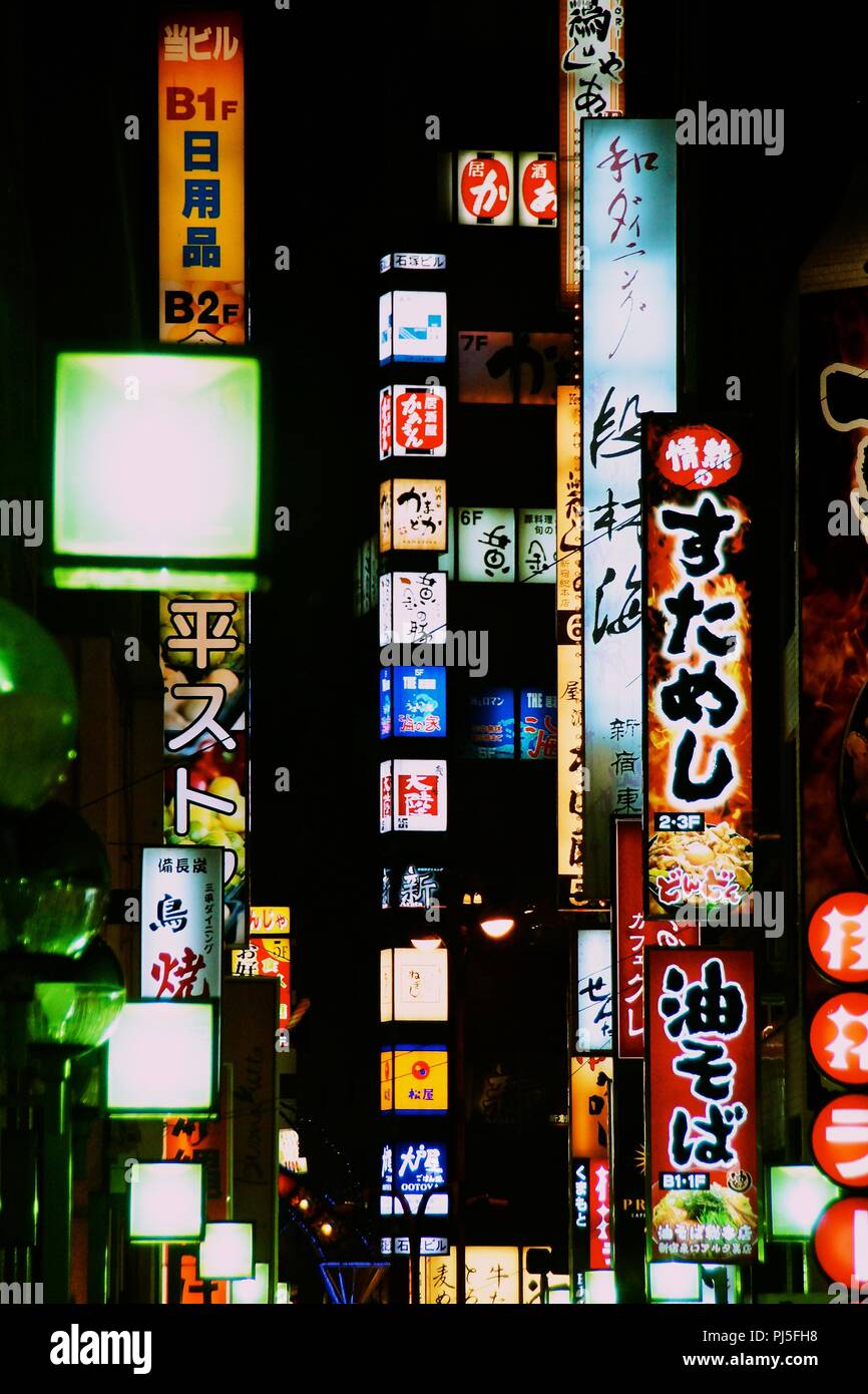 Bright signs in Tokyo night Stock Photo - Alamy