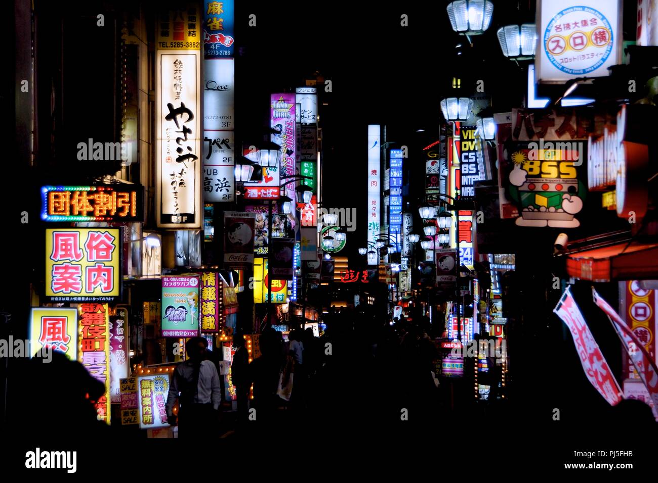 Bright signs in Tokyo night Stock Photo - Alamy