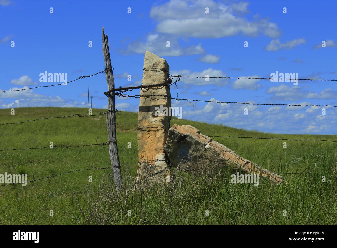 Kansas Stone Post with a gate and fence with blue sky and clouds Stock ...