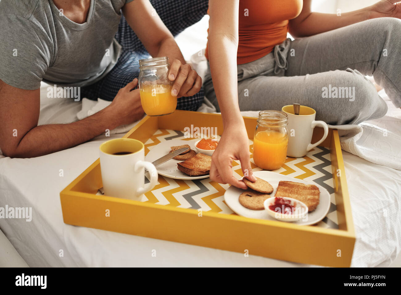 Young latino couple relaxing in bed at home. Hispanic husband and wife ...