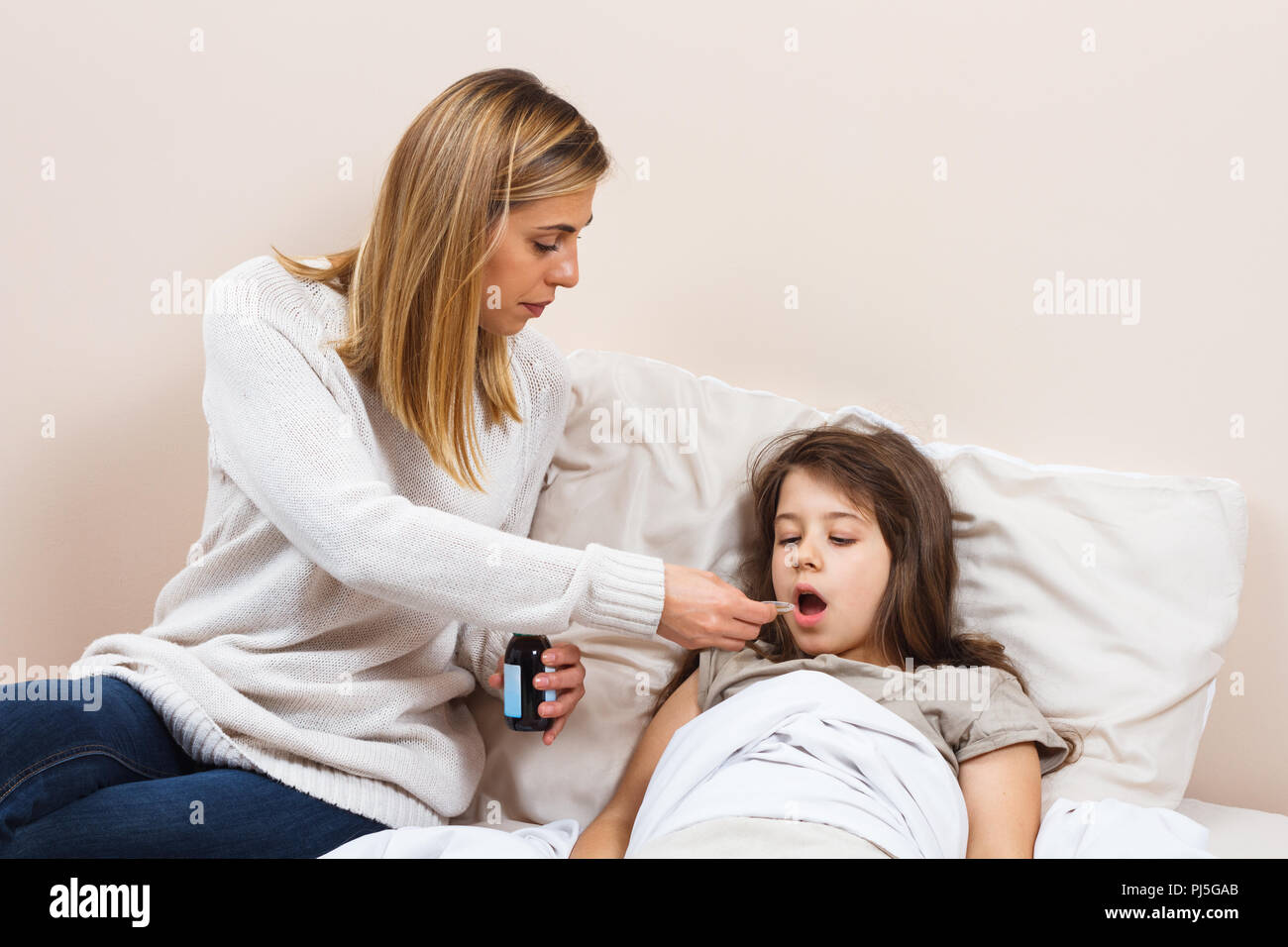 Taking medicine, child, spoon hi-res stock photography and images - Alamy