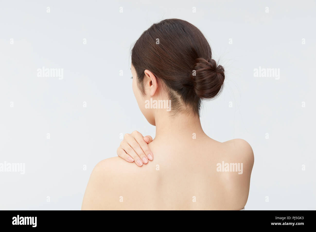 Japanese woman massaging Stock Photo - Alamy
