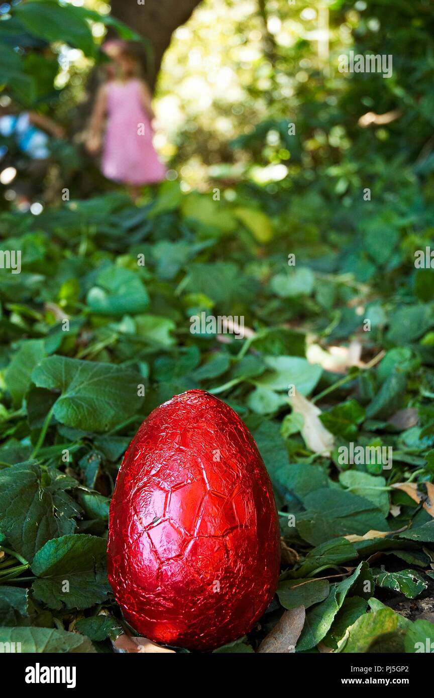 A little boy and girl hunting for chocolate Easter eggs Stock Photo - Alamy