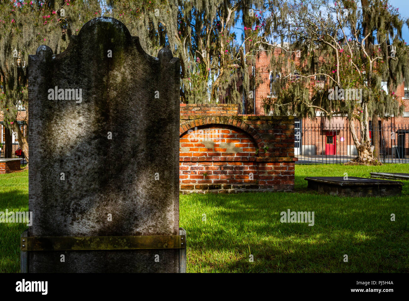 A grave headstone with the enscription eroded away due to age and ...