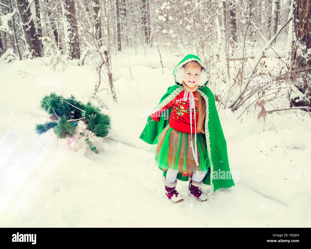 a red-haired girl with long hair in a lush skirt and a green cloak with ...